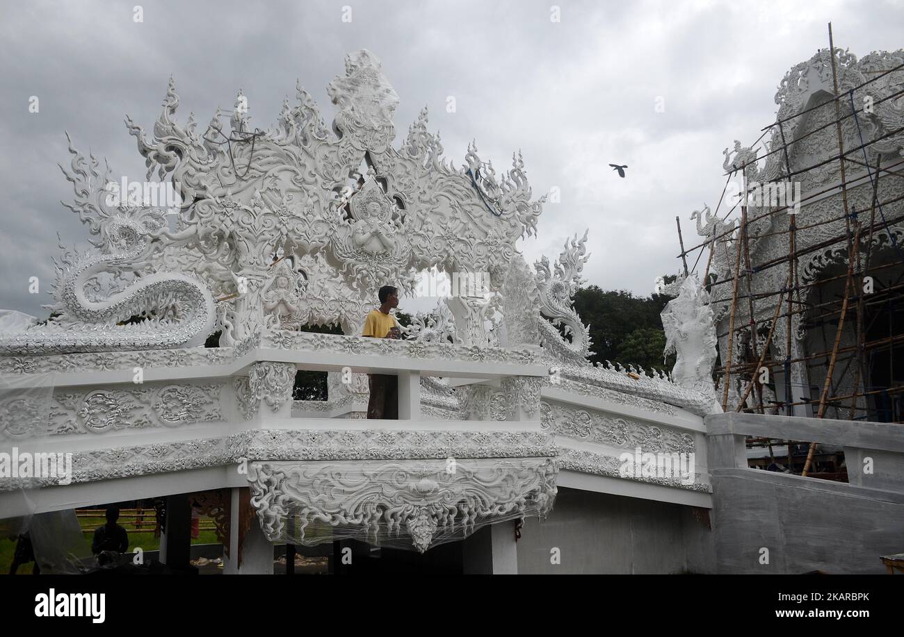 An Indian artisan prepares the temple of Thailand in a Puja pandal of ...