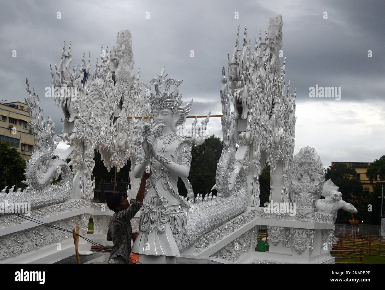 An Indian artisan prepares the temple of Thailand in a Puja pandal of ...