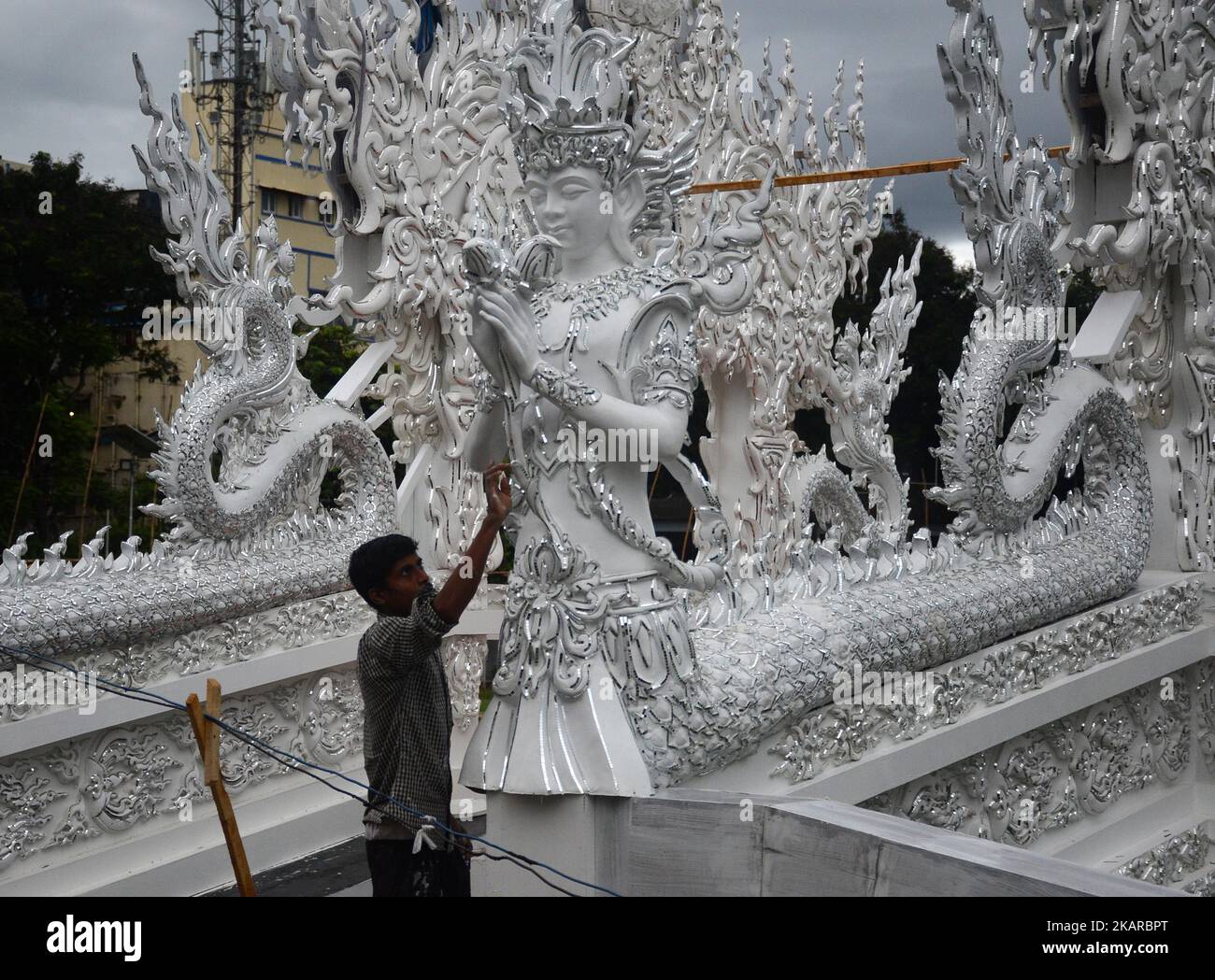 An Indian artisan prepares the temple of Thailand in a Puja pandal of ...