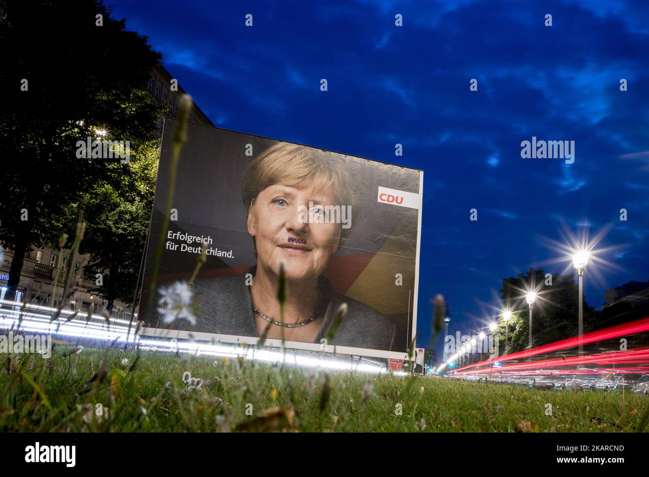 A vandalized election poster of German Chancellor Angela Merkel (CDU ...
