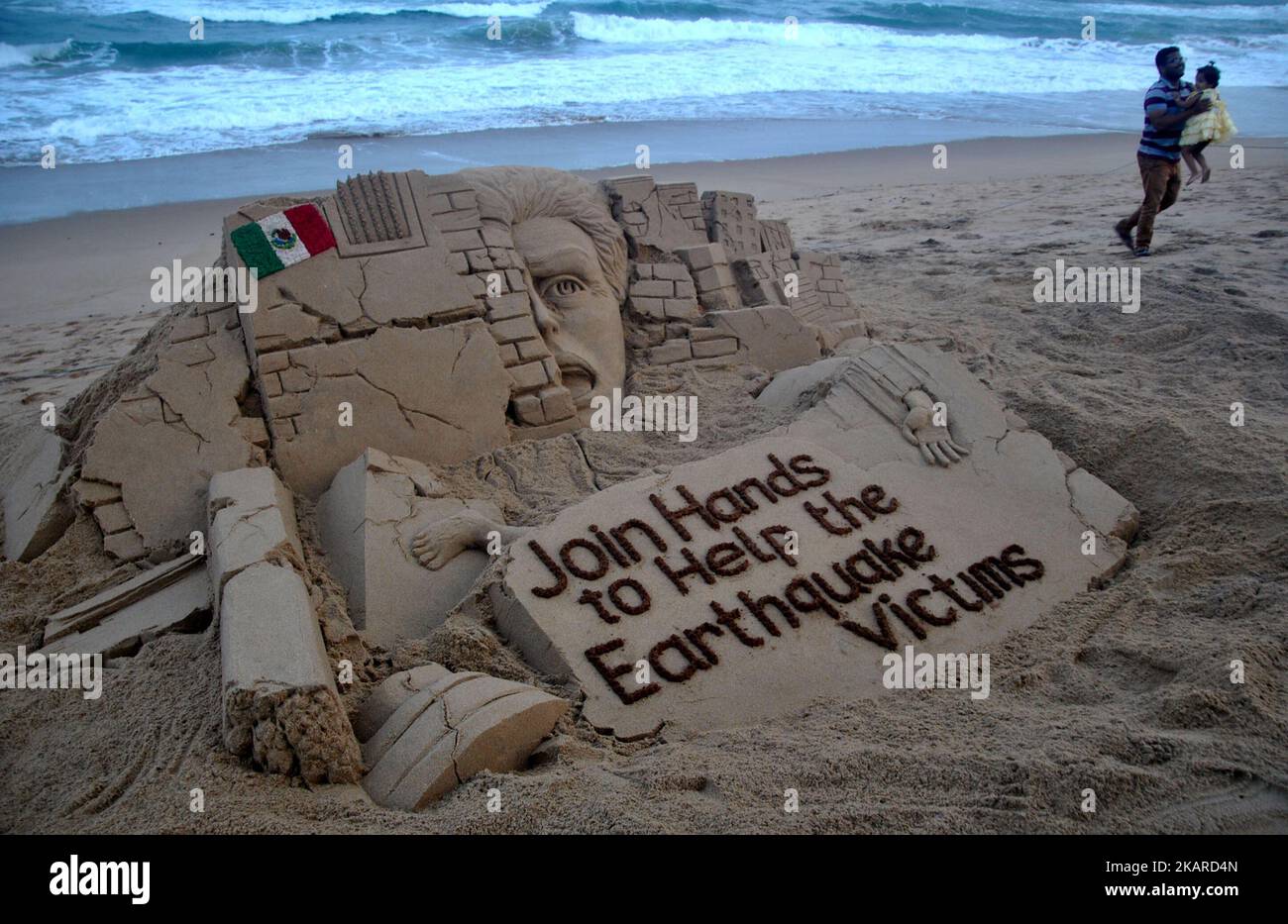 A sand art is seen on the Bay of Bengal Sea's eastern coast at Puri ...