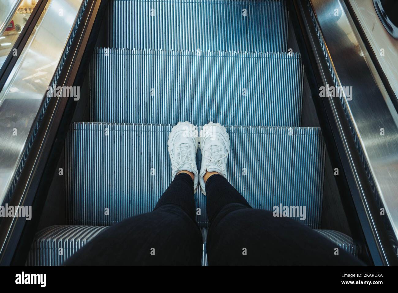Shoes on escalator hi-res stock photography and images - Alamy