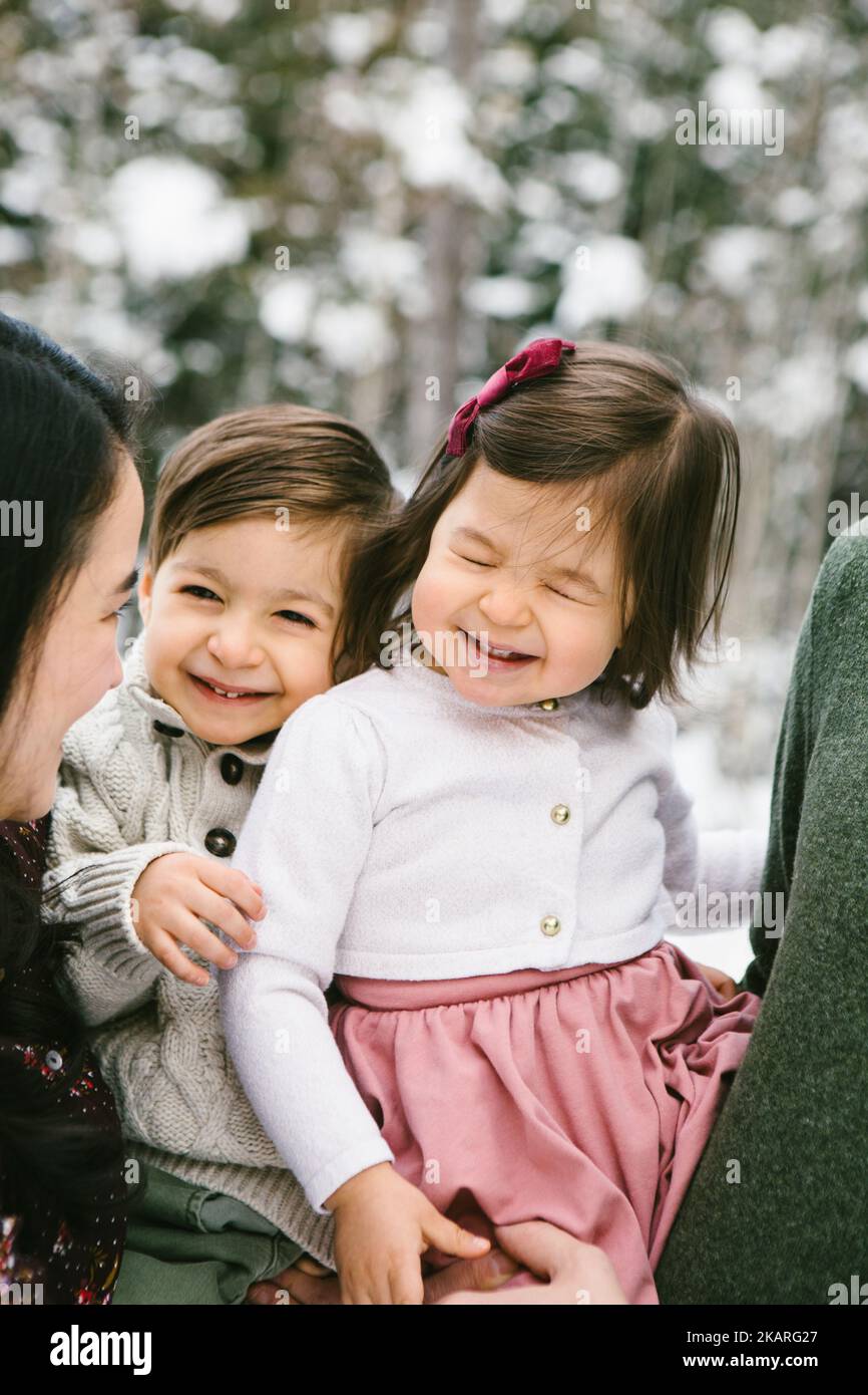 Toddler brother and sister laugh and smile in snow forest Stock Photo ...