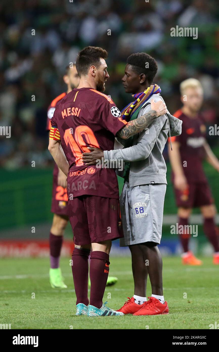 A fan of Barcelona's Argentine forward Lionel Messi enters the field to ...