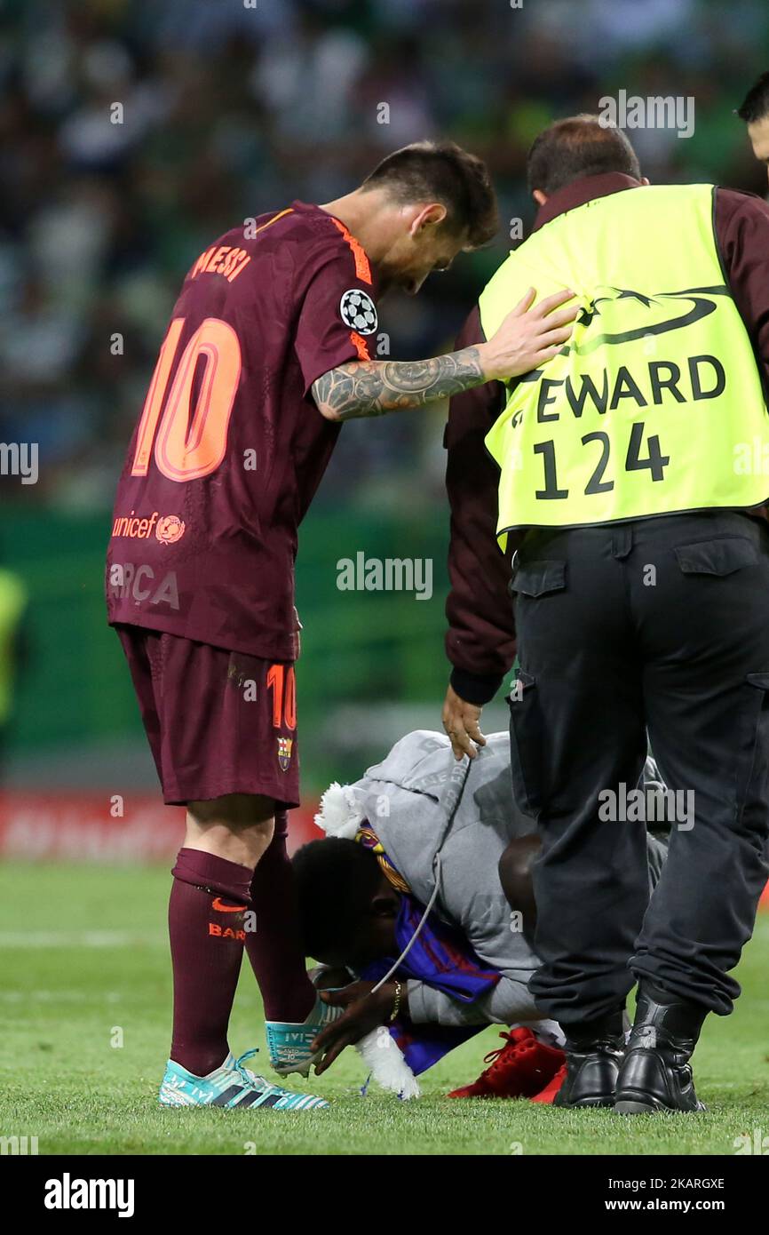 A fan of Barcelona's Argentine forward Lionel Messi enters the field ...