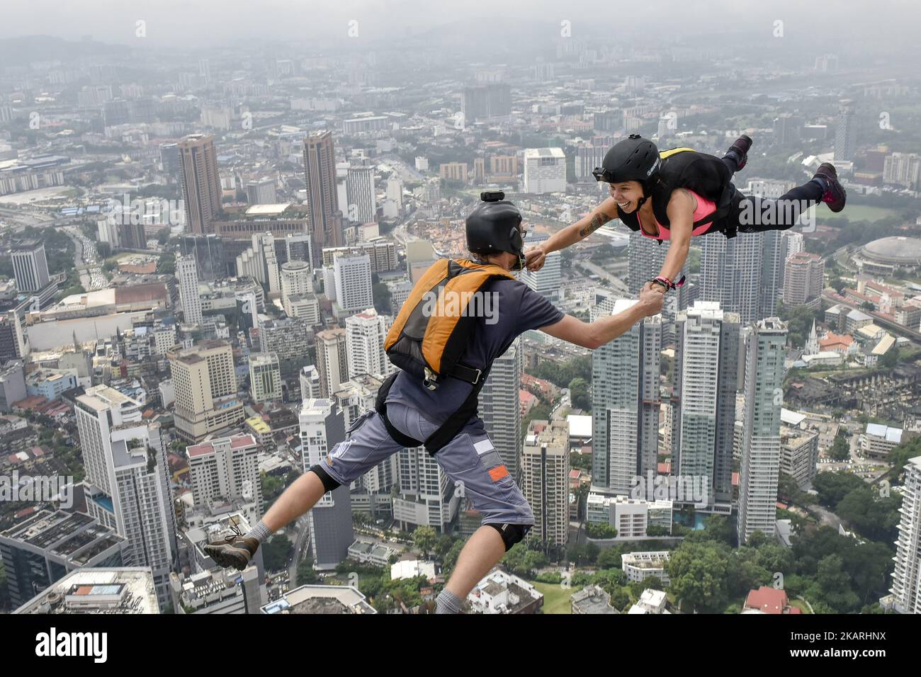 Base jumpers leaps from the 300 meter high open deck at Kuala Lumpur ...
