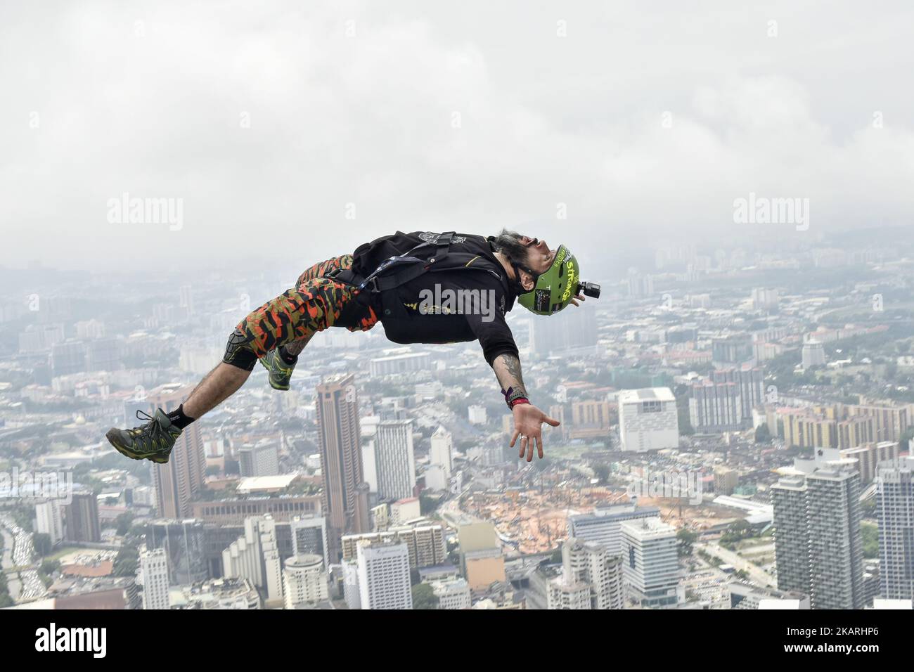 Base jumpers leaps from the 300 meter high open deck at Kuala Lumpur ...