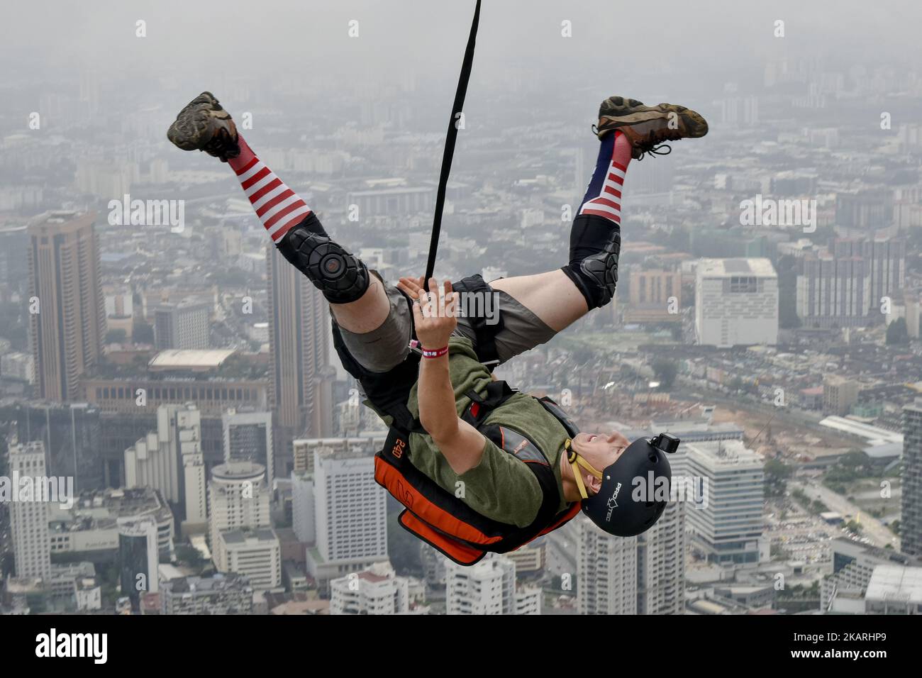 Base jumpers leaps from the 300 meter high open deck at Kuala Lumpur ...