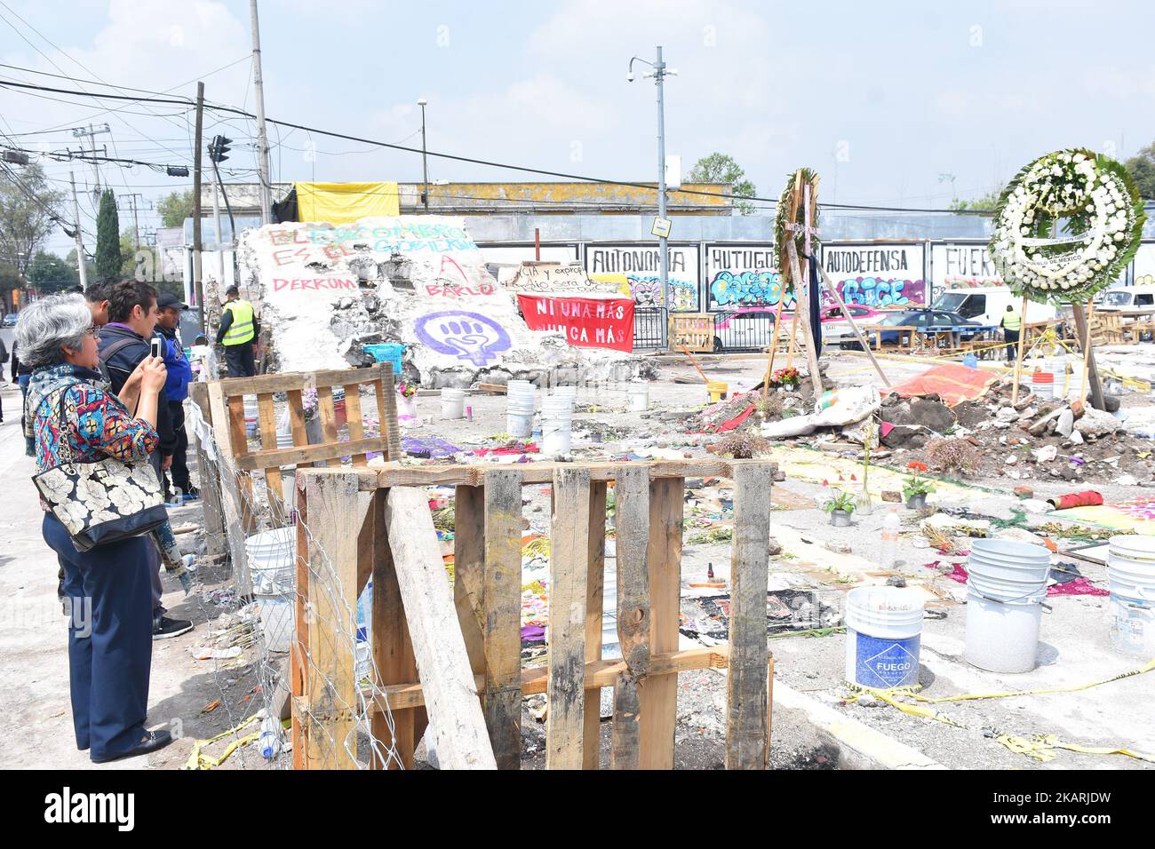 People visit the altar in honor of the victims who died in the sewing ...