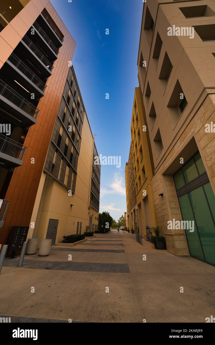 A vertical shot of a narrow path between residential buildings Stock ...
