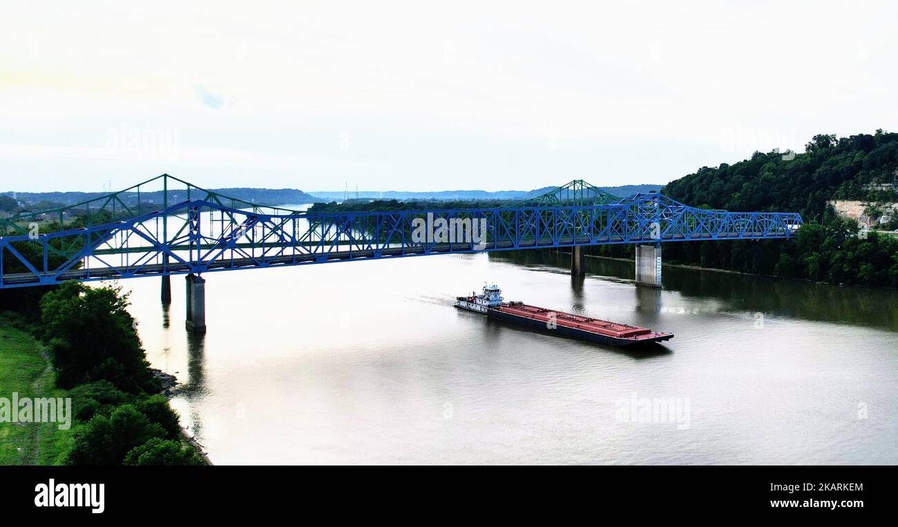 The Huntington Bridge over the Ohio river with a boat on the water ...