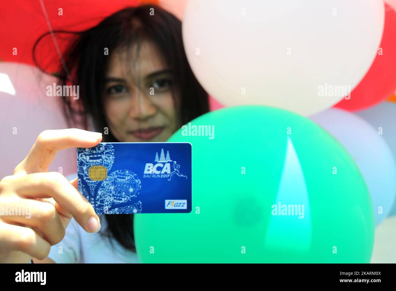 Model shows the electronic cards by banks in Indonesia during the ...