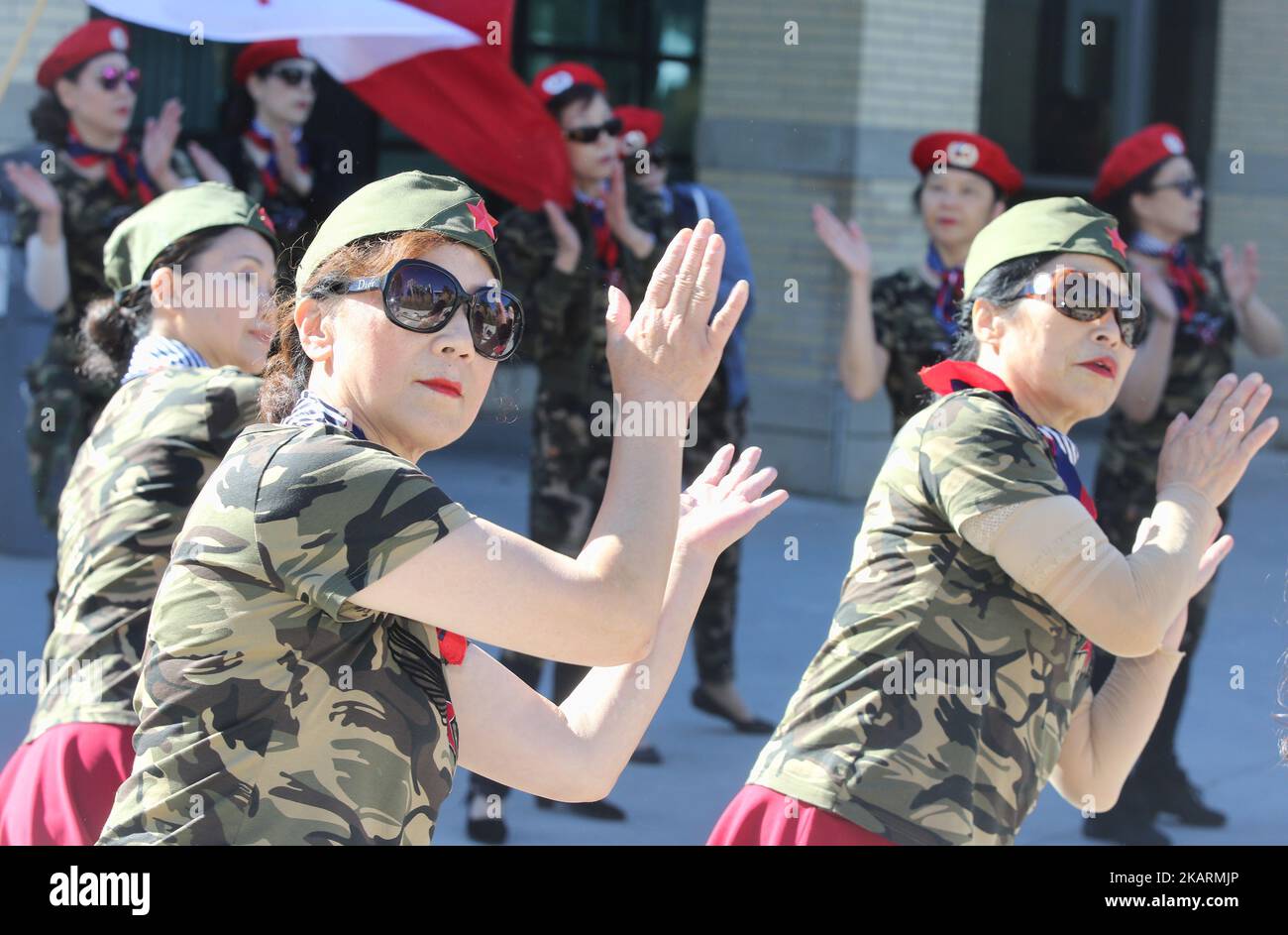Chinese dancers dressed in military fatigues practice before a ...