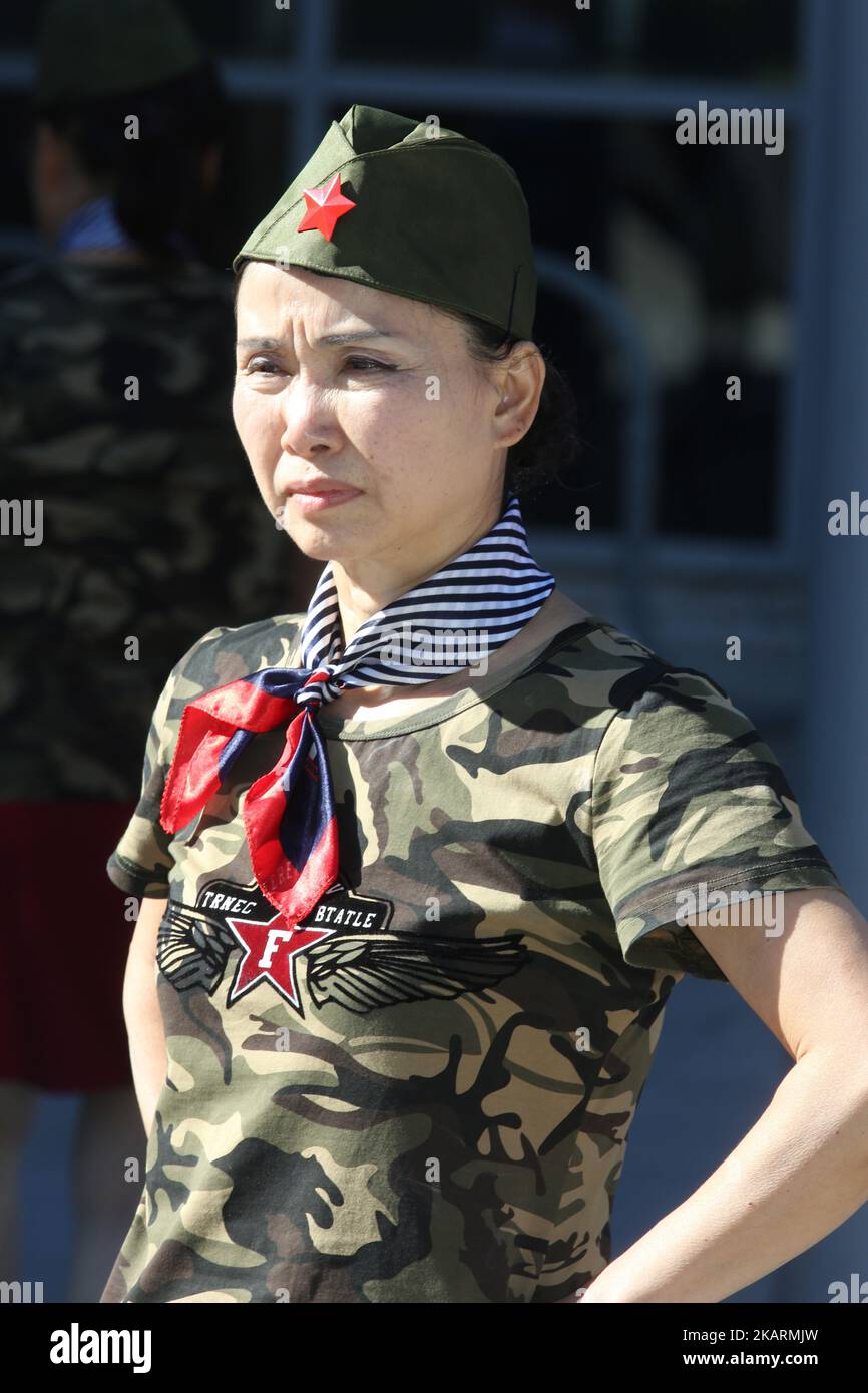 Chinese dancers dressed in military fatigues practice before a ...