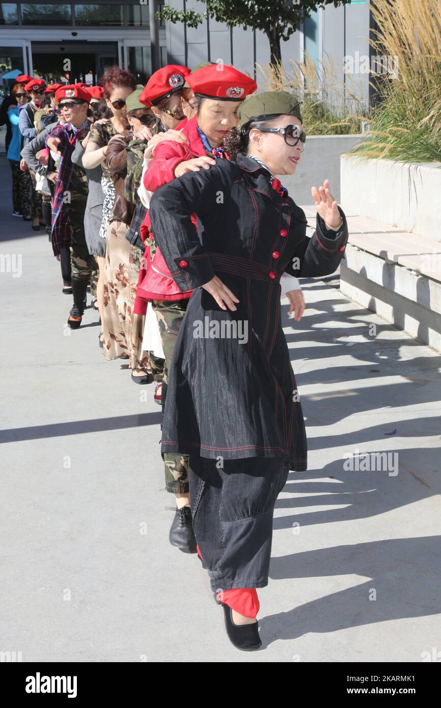 Chinese dancers dressed in military fatigues practice before a ...