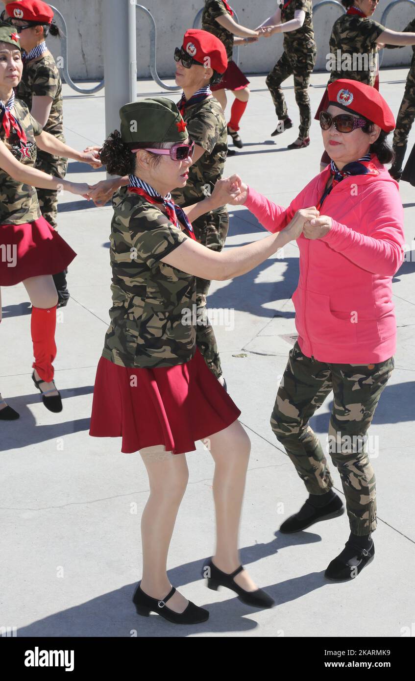 Chinese dancers dressed in military fatigues practice before a ...