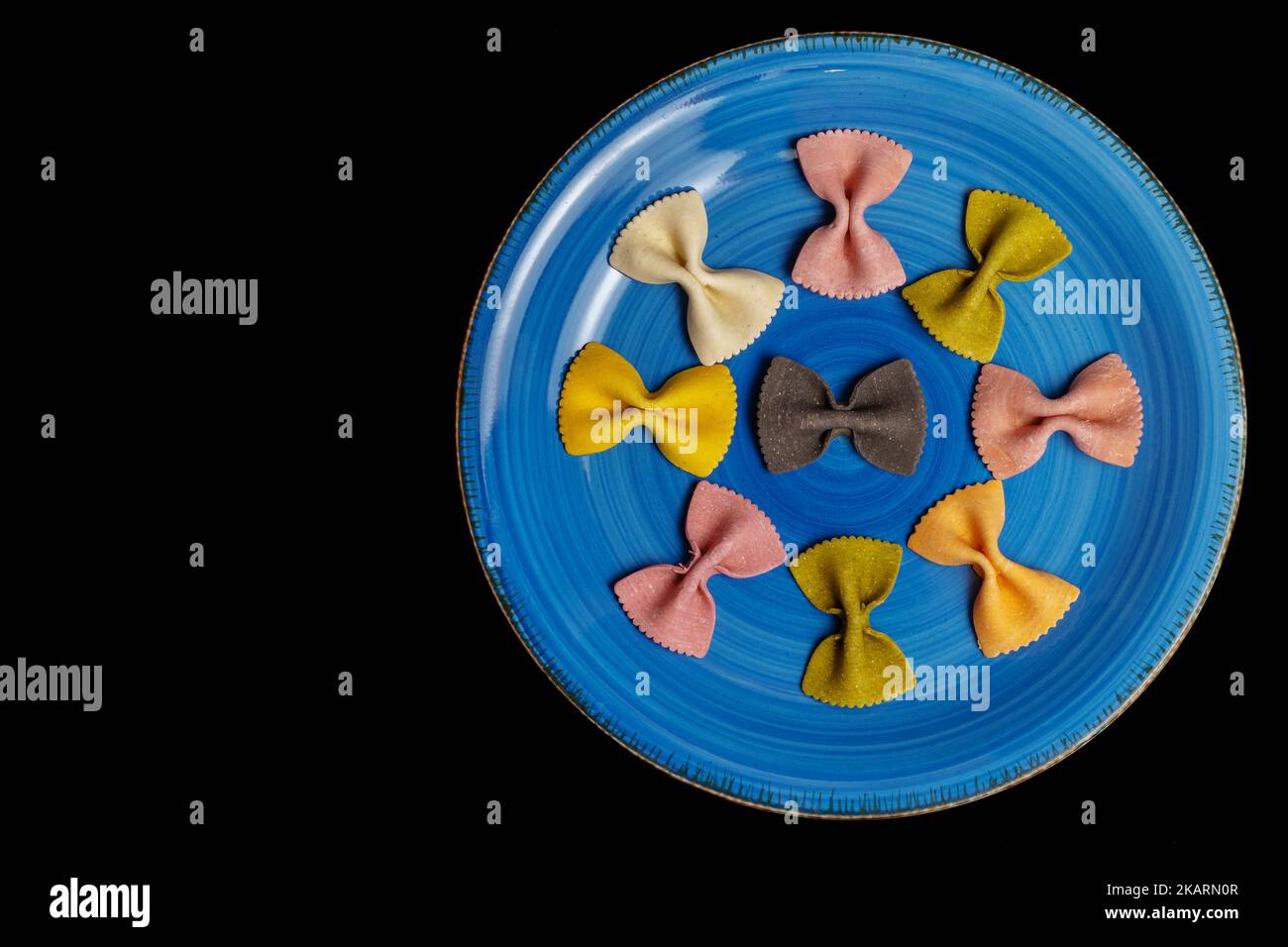 colored raw farfalle pasta on a plate Stock Photo - Alamy