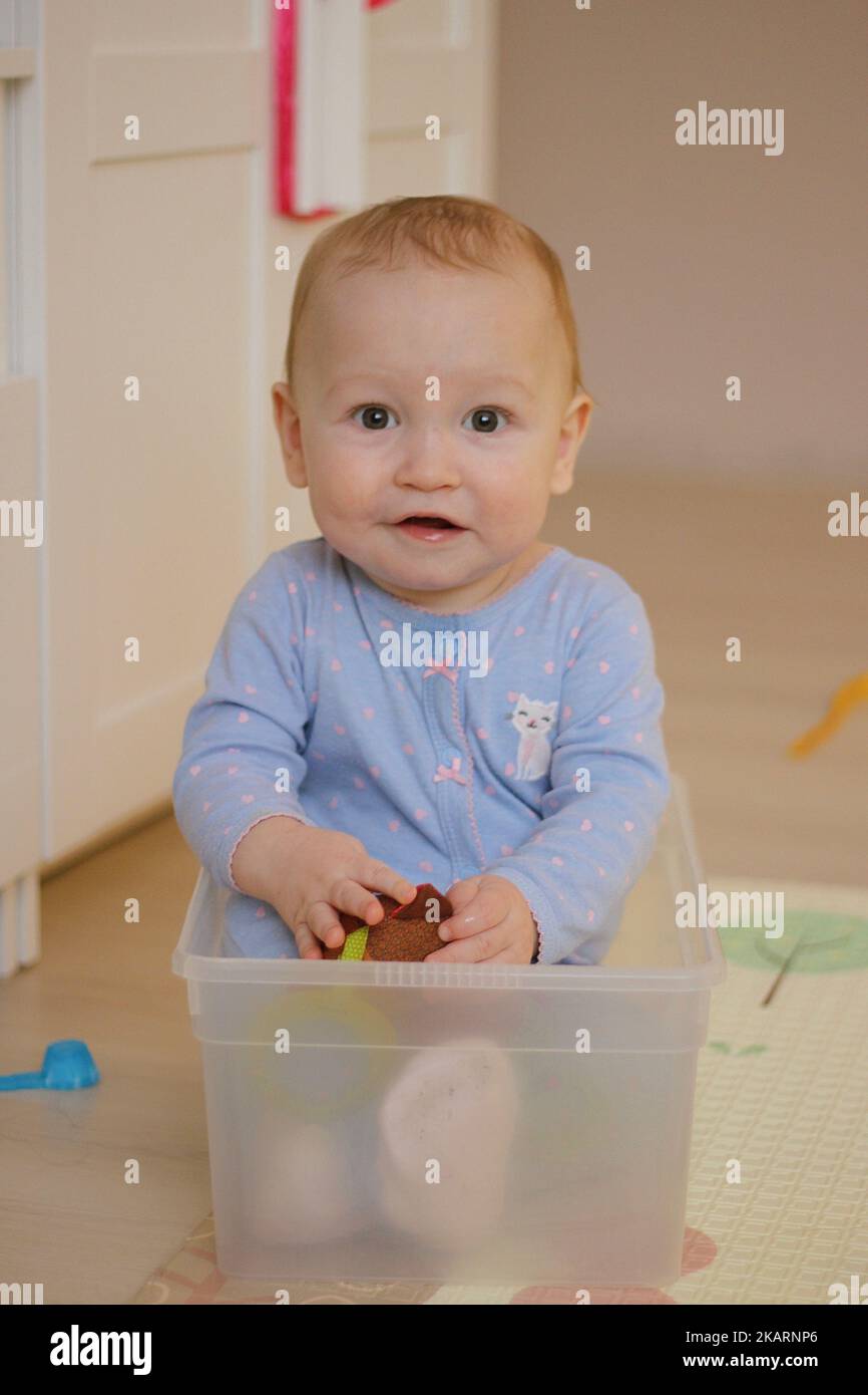 Baby boy sitting in box Stock Photo - Alamy