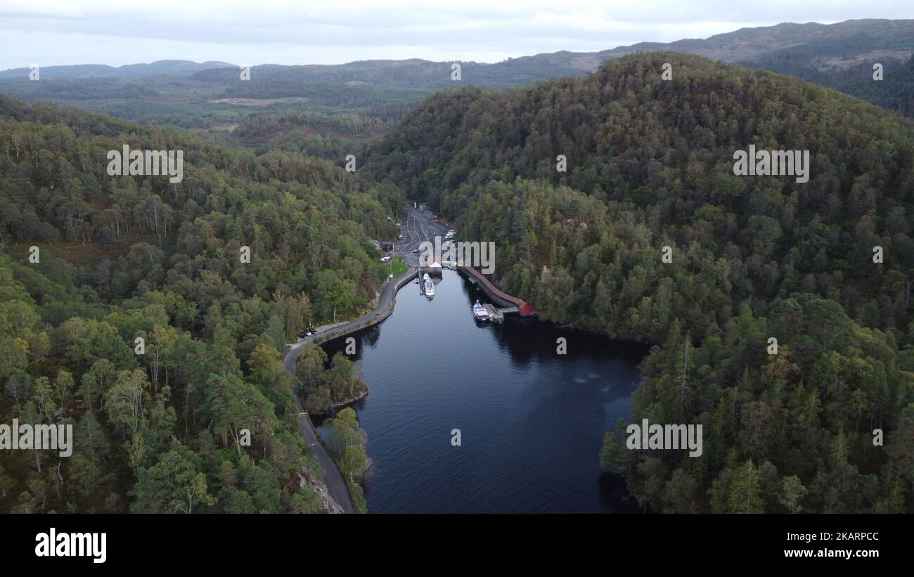 An aerial shot of the Loch Venachar in Scotland surrounded by green ...