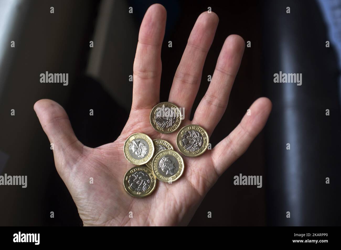 The old £1 coins are pictured alongside the new 12-sided one pound ...