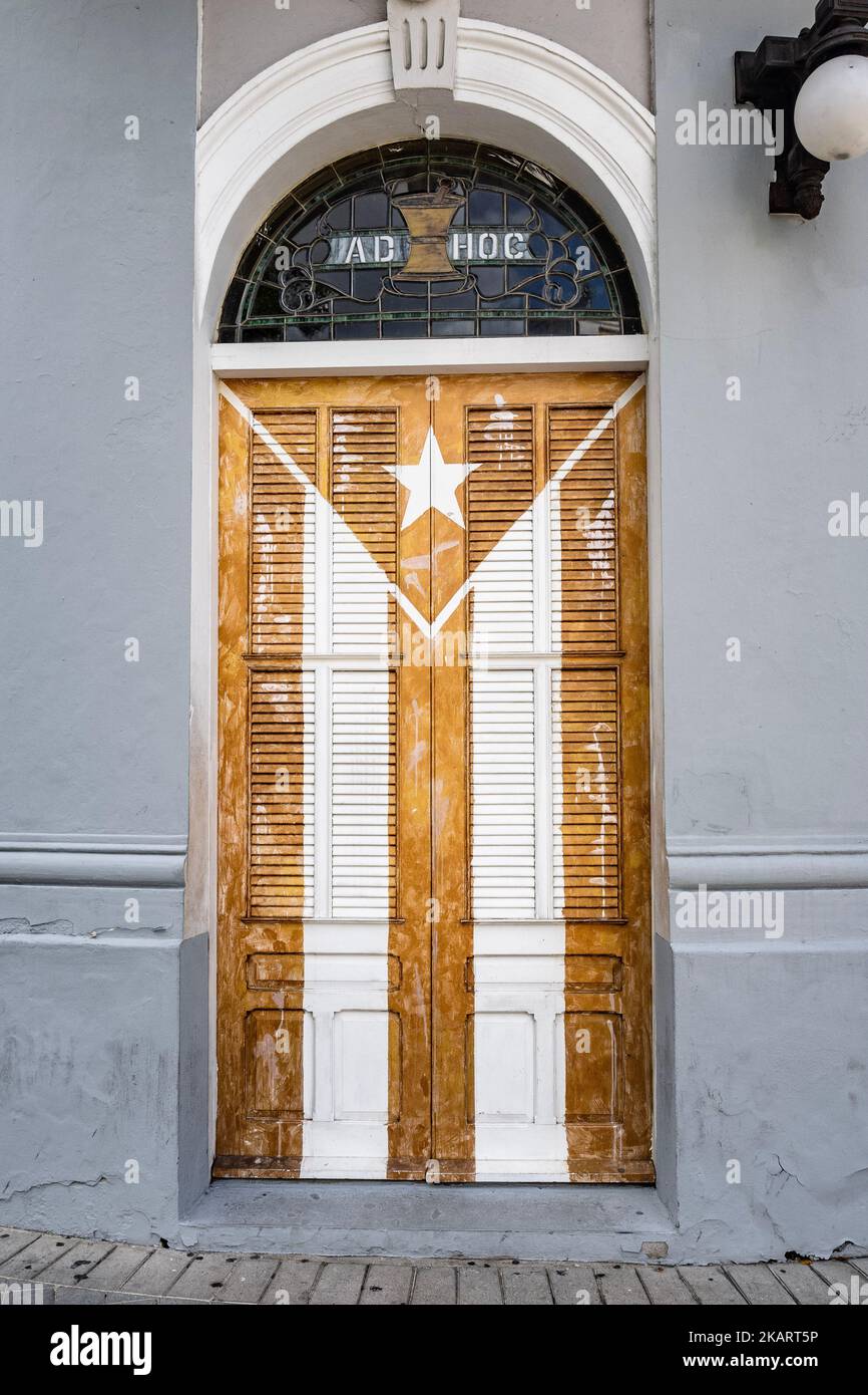 A vertical shot of the Puerto Rican flag painted in gold as one of the ...