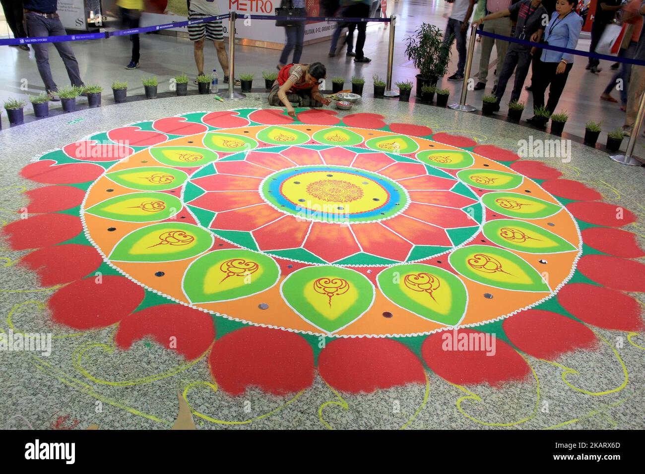 An artist prepares Rangoli ahead of the auspicious occasion of Diwali ...
