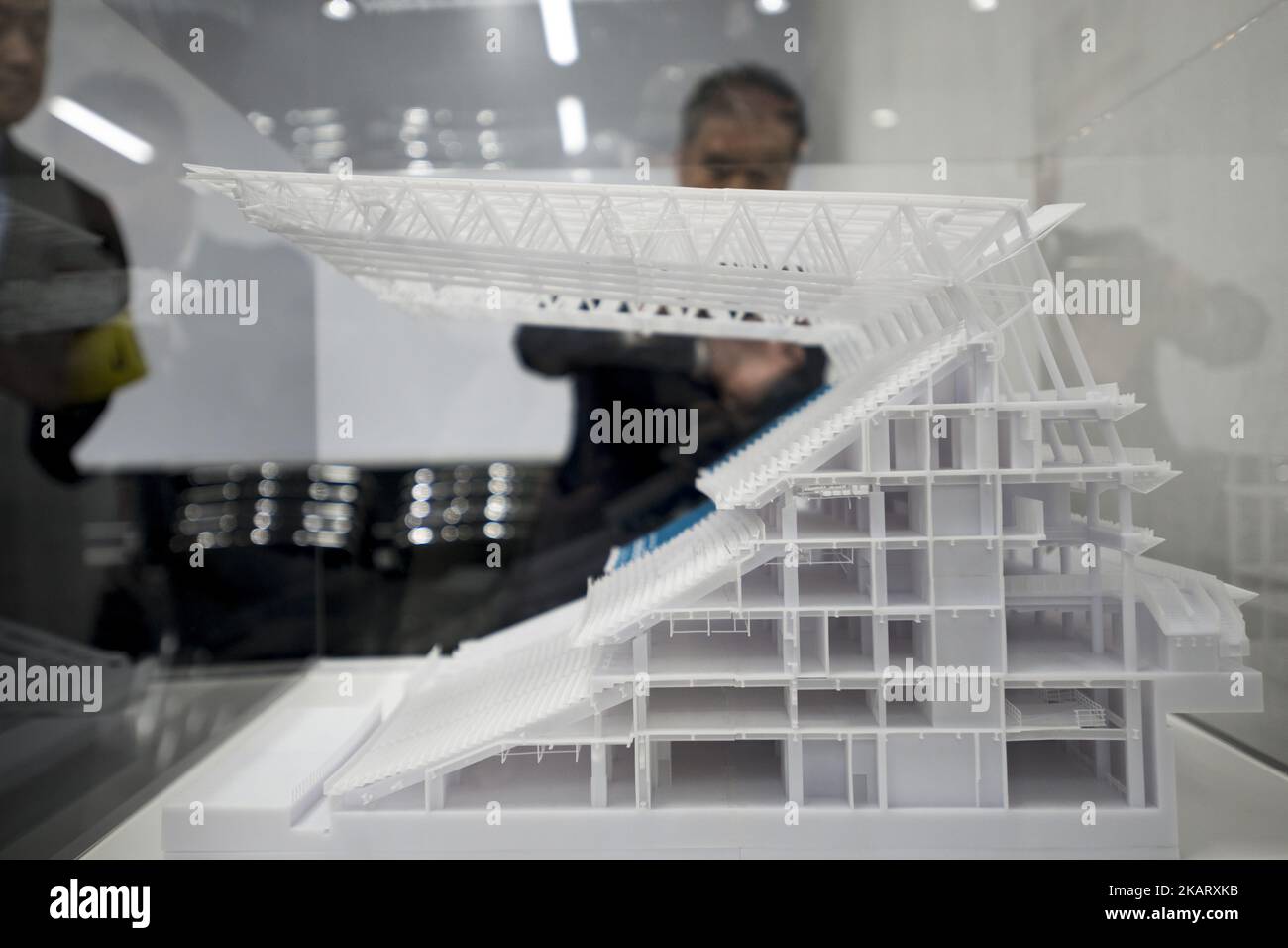 Photographers take a photo of the 1/150 scale model of the new national ...