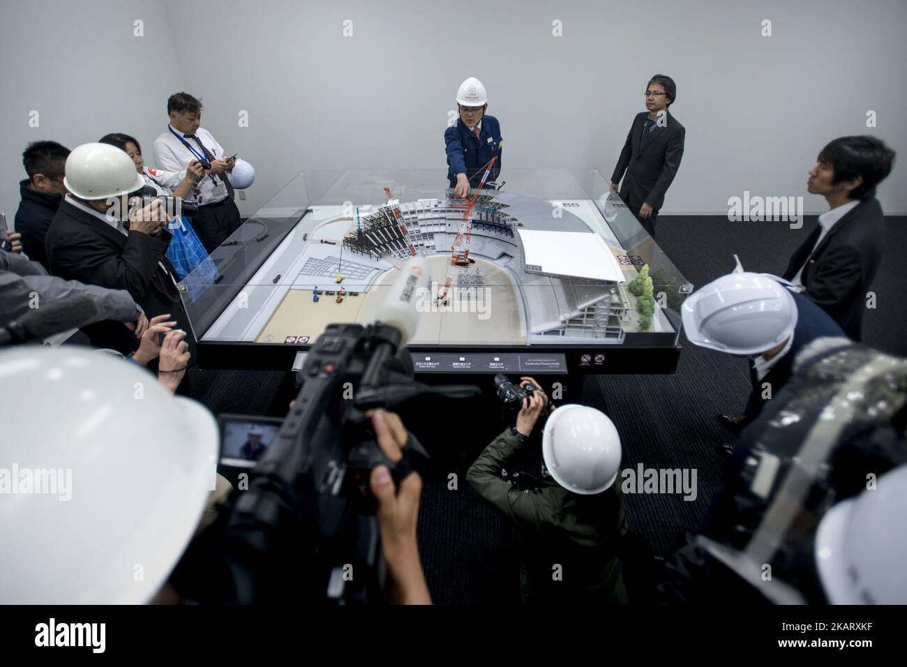 Photographers take a photo of the 1/150 scale model of the new national ...