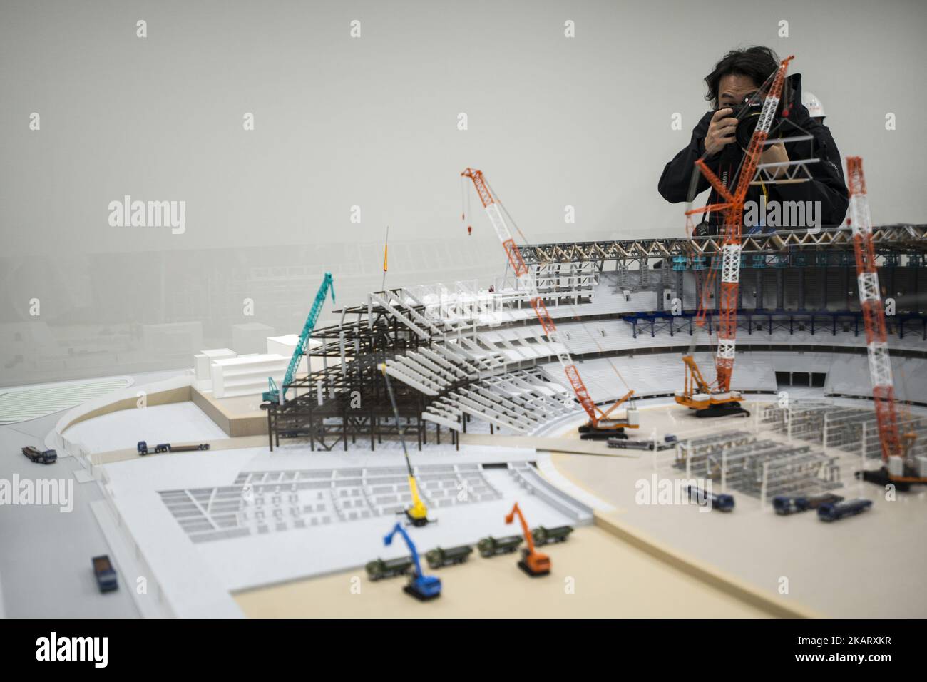 Photographers take a photo of the 1/150 scale model of the new national ...