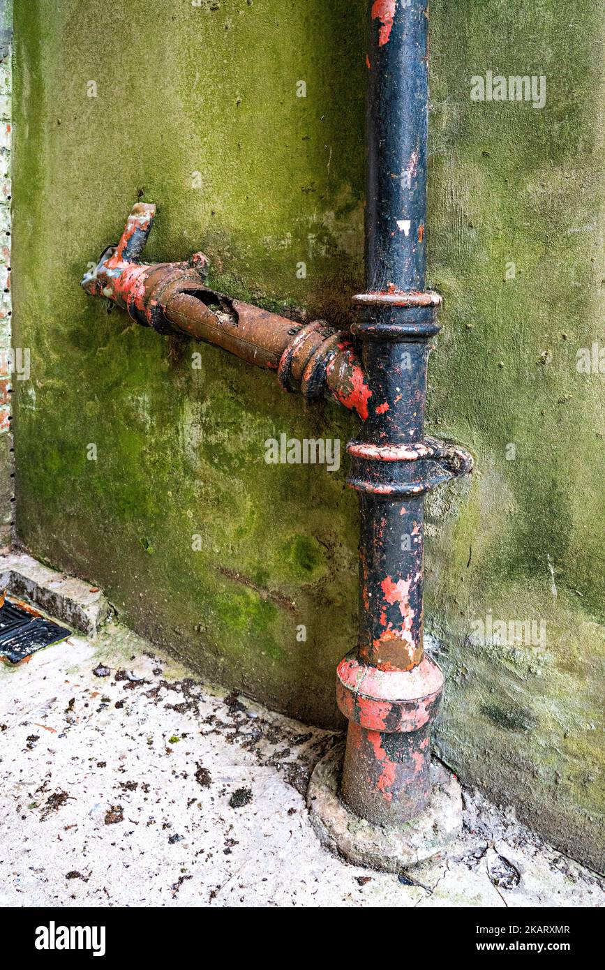 Broken cast iron domestic exterior drainpipes Stock Photo - Alamy
