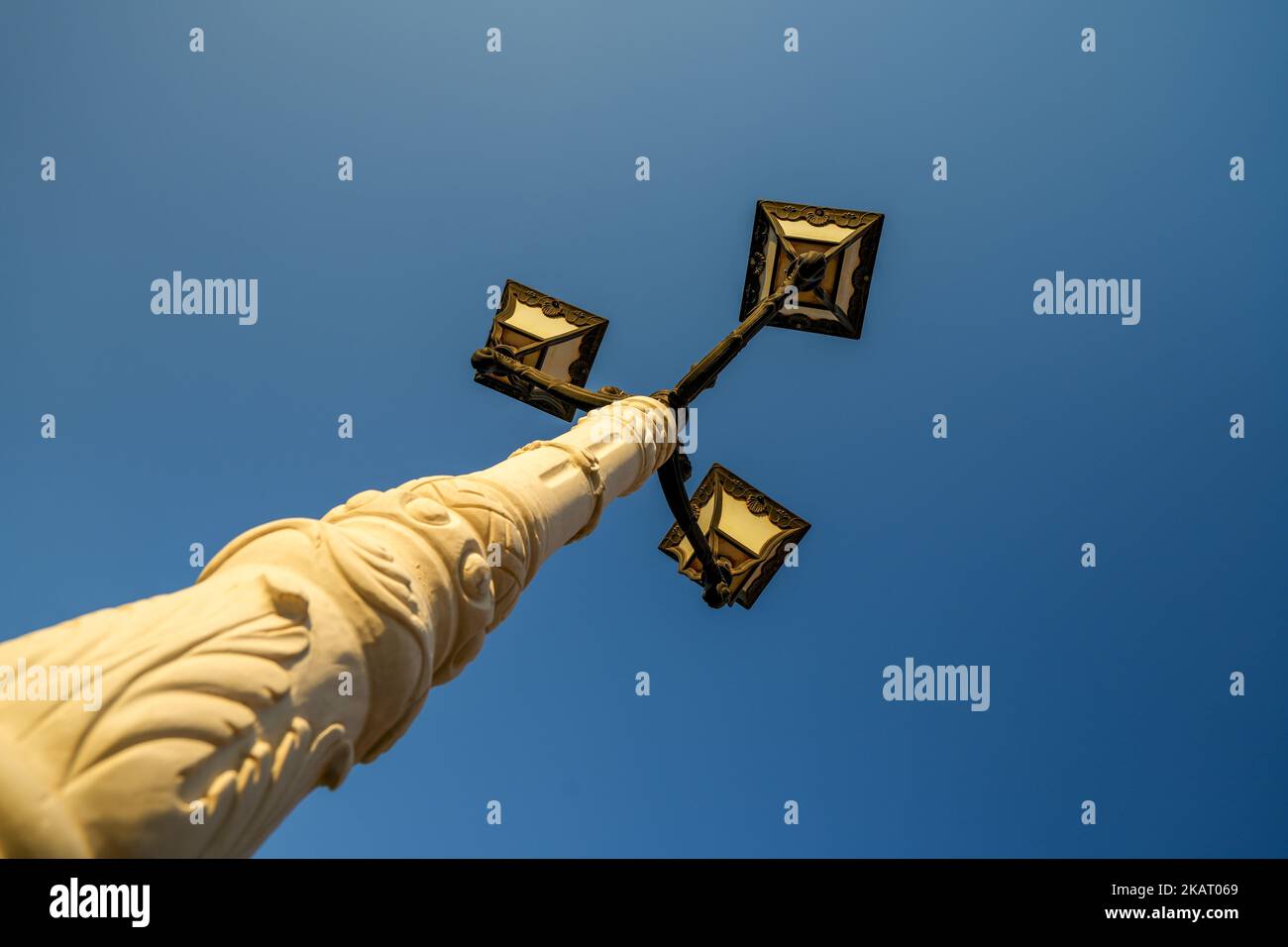 A low angle shot of the beautiful street lamp on a blue sky background ...