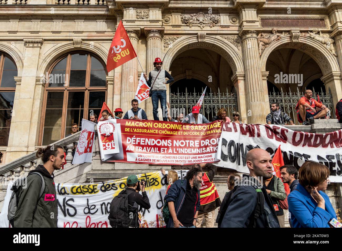 People march behind a banner as thousands gather in the streets of Lyon ...