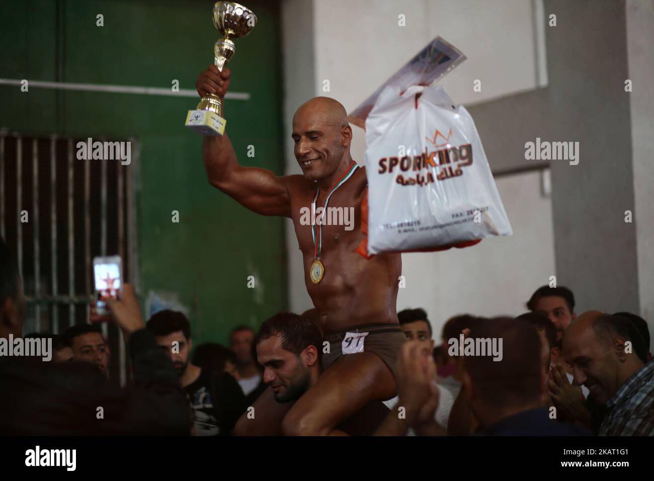 A Palestinian contestant celebrates winning a bodybuilding competition ...