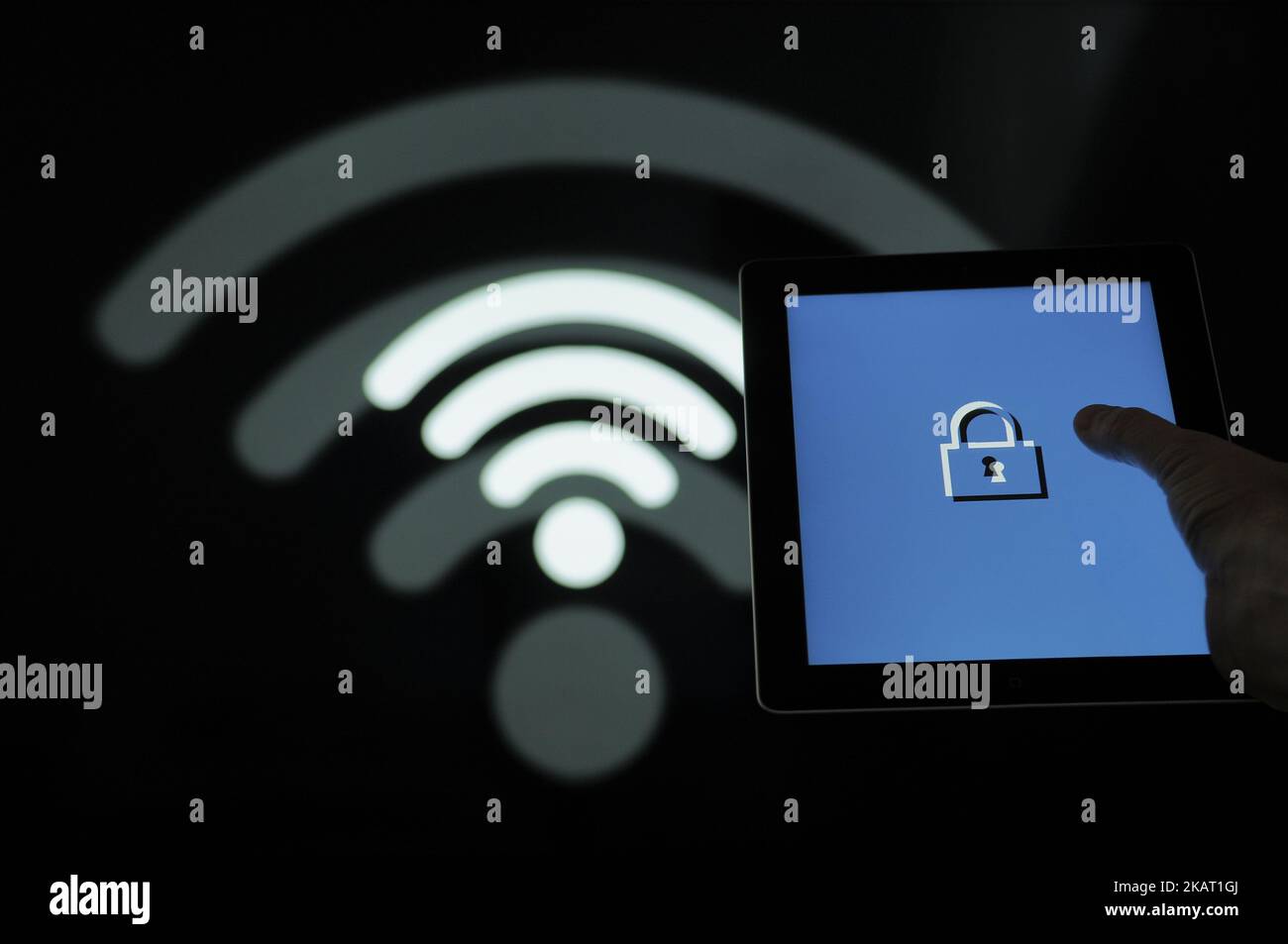 A computer tablet with a security lock symbol with WiFi logos in the ...