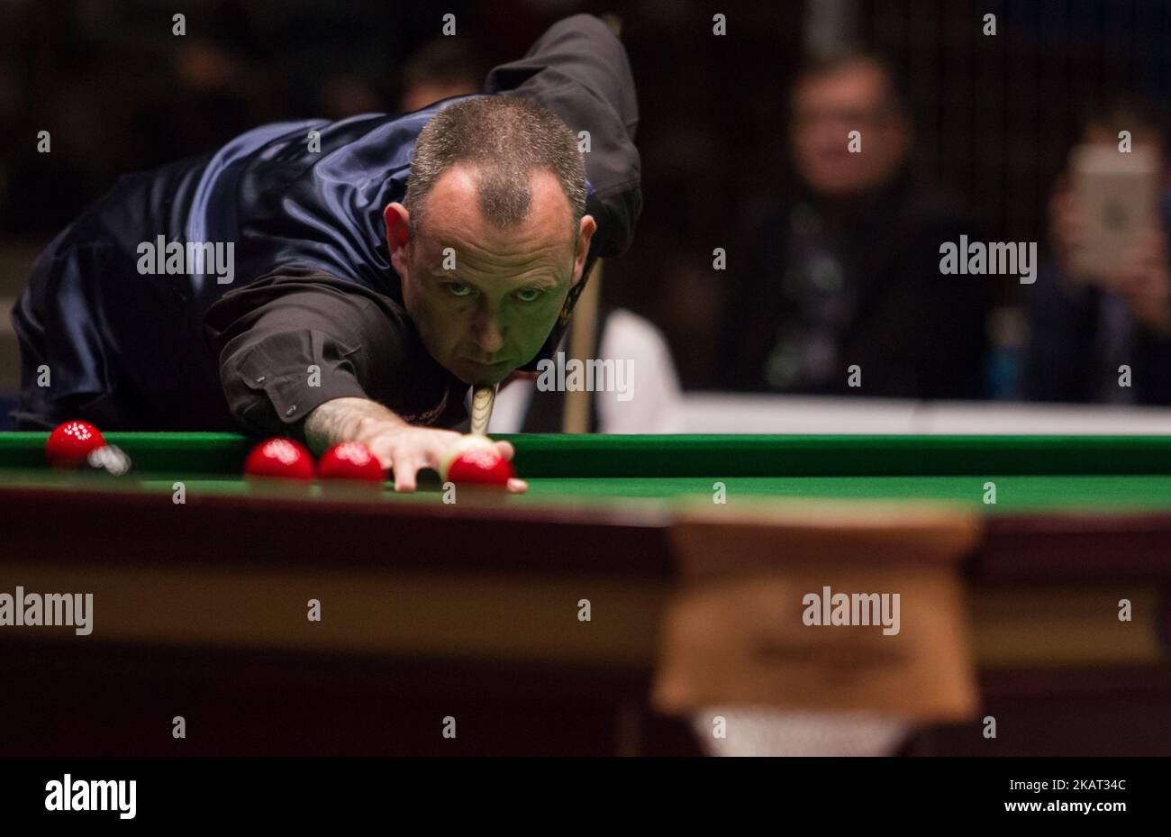 Mark J. Williams of Wales plays a shot against Steve Davis of Great ...