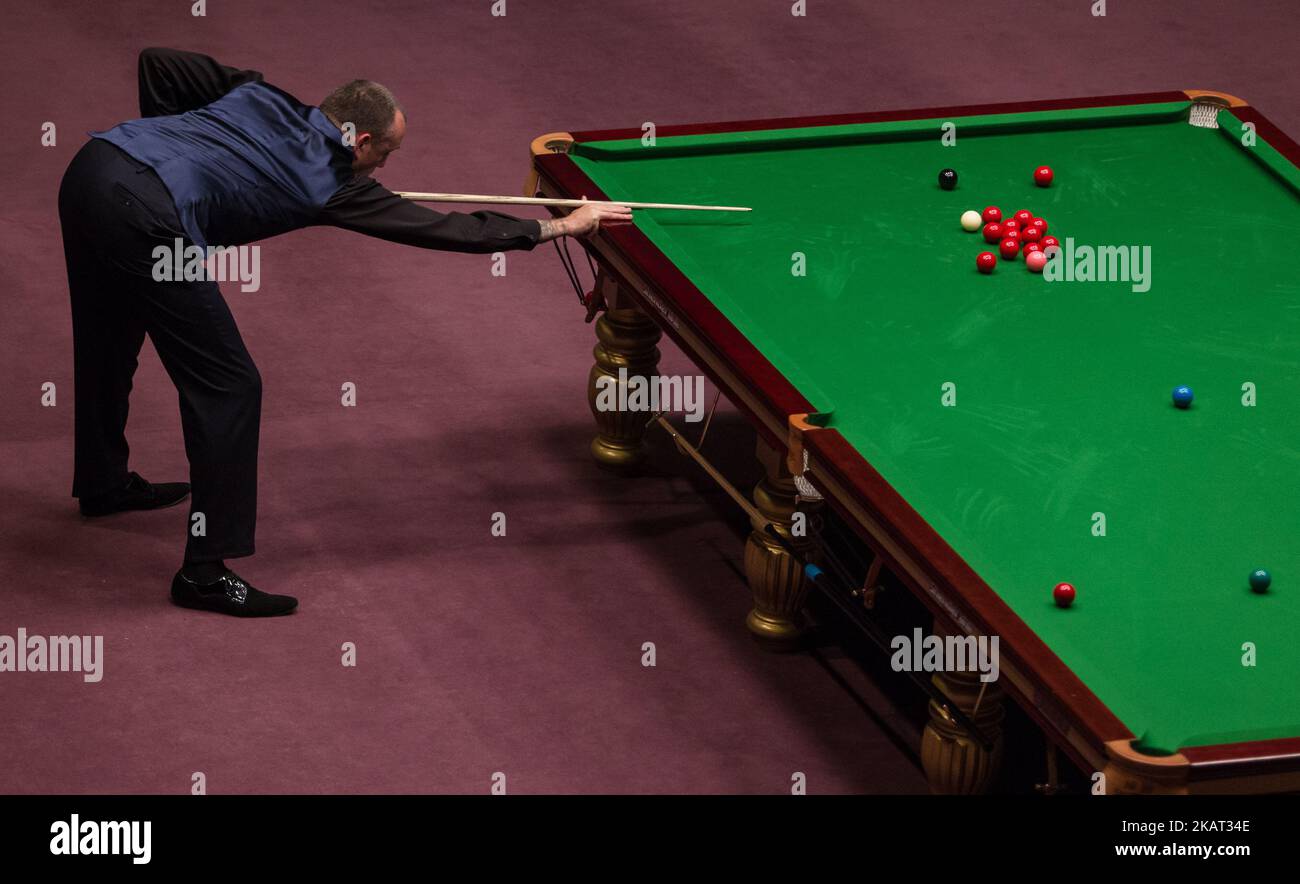 Mark J. Williams of Wales plays a shot against Steve Davis of Great ...