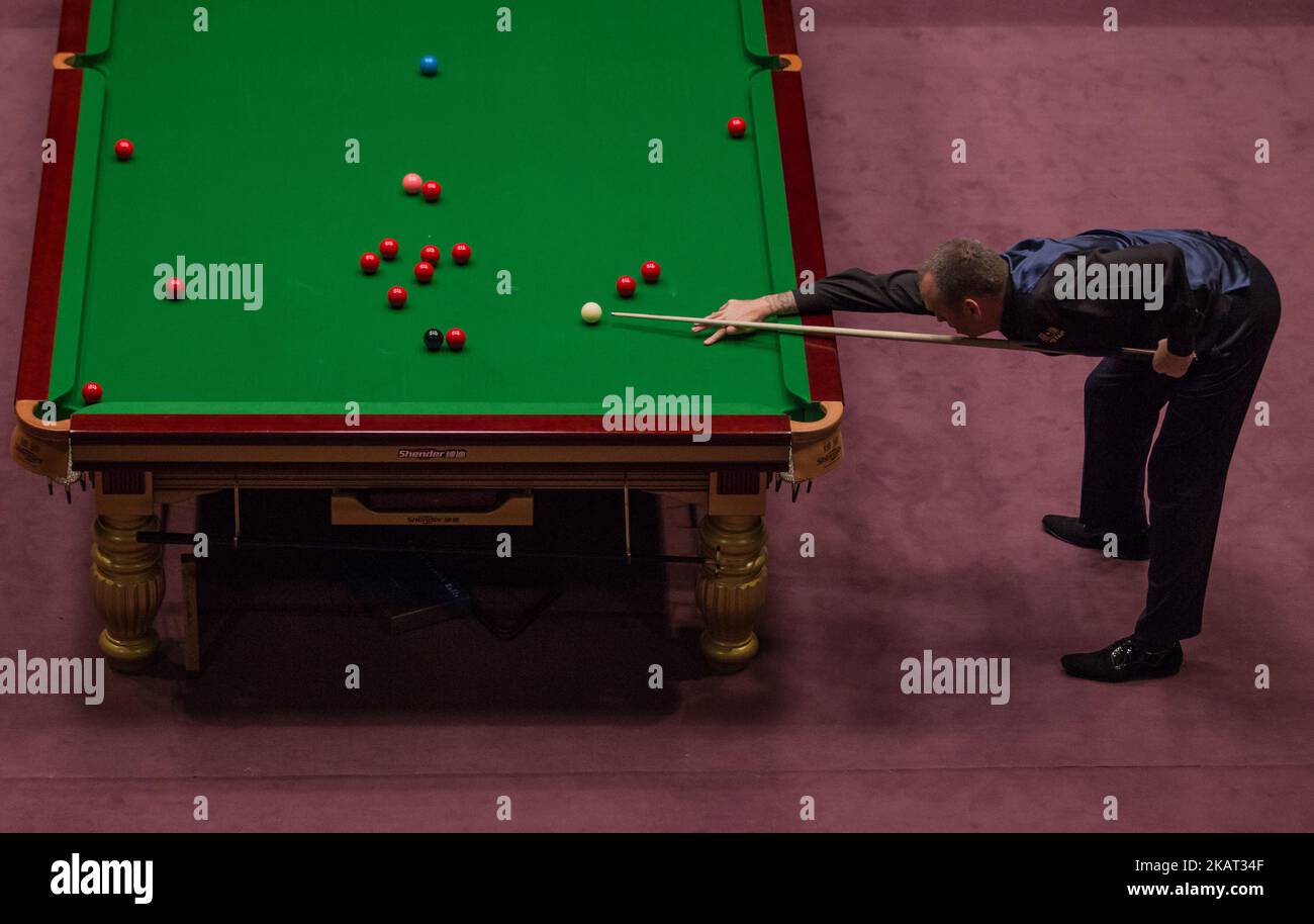 Mark J. Williams of Wales plays a shot against Steve Davis of Great ...