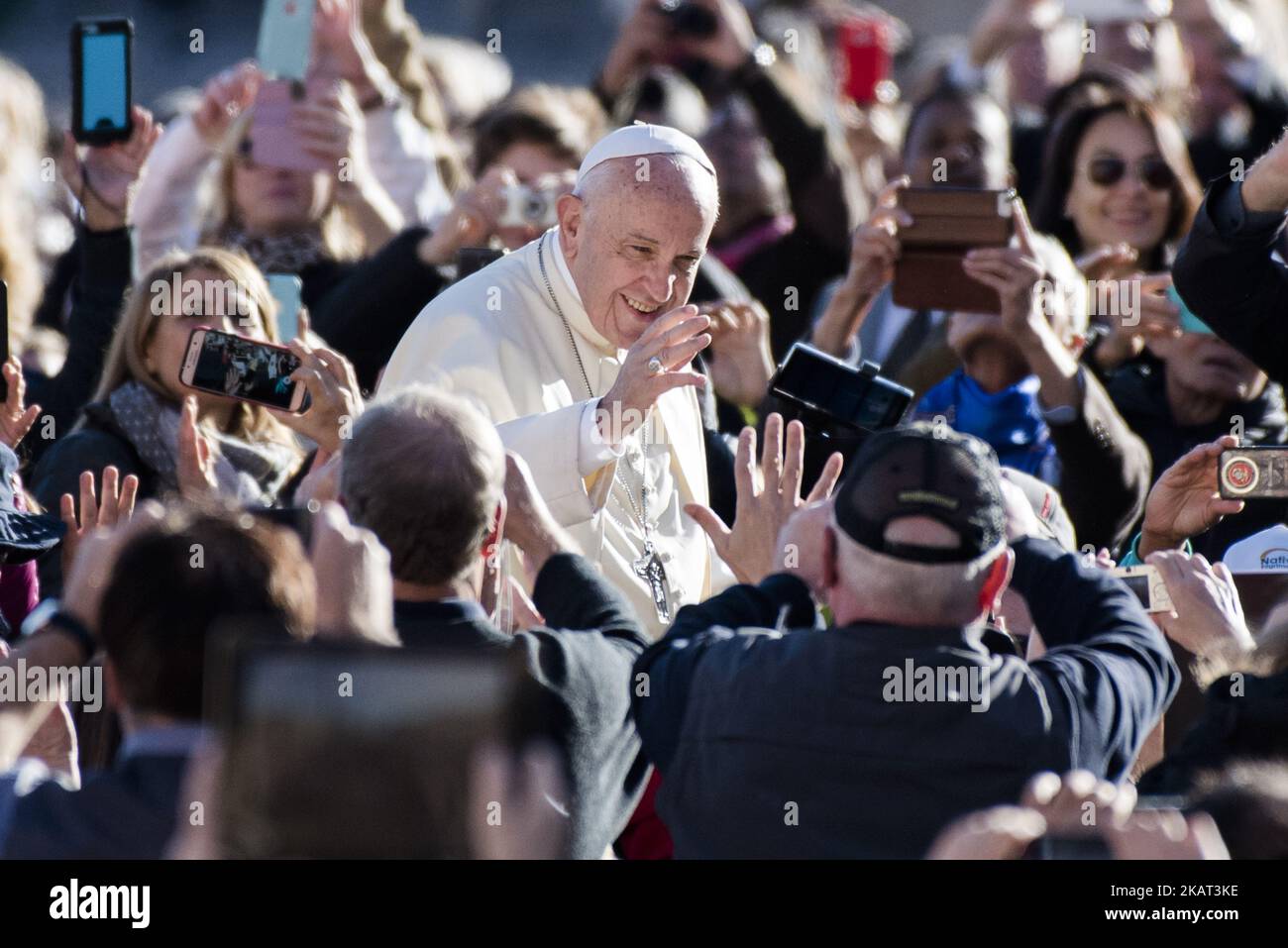 Pope Francis greets to faithful as he tours through the crowd attending ...