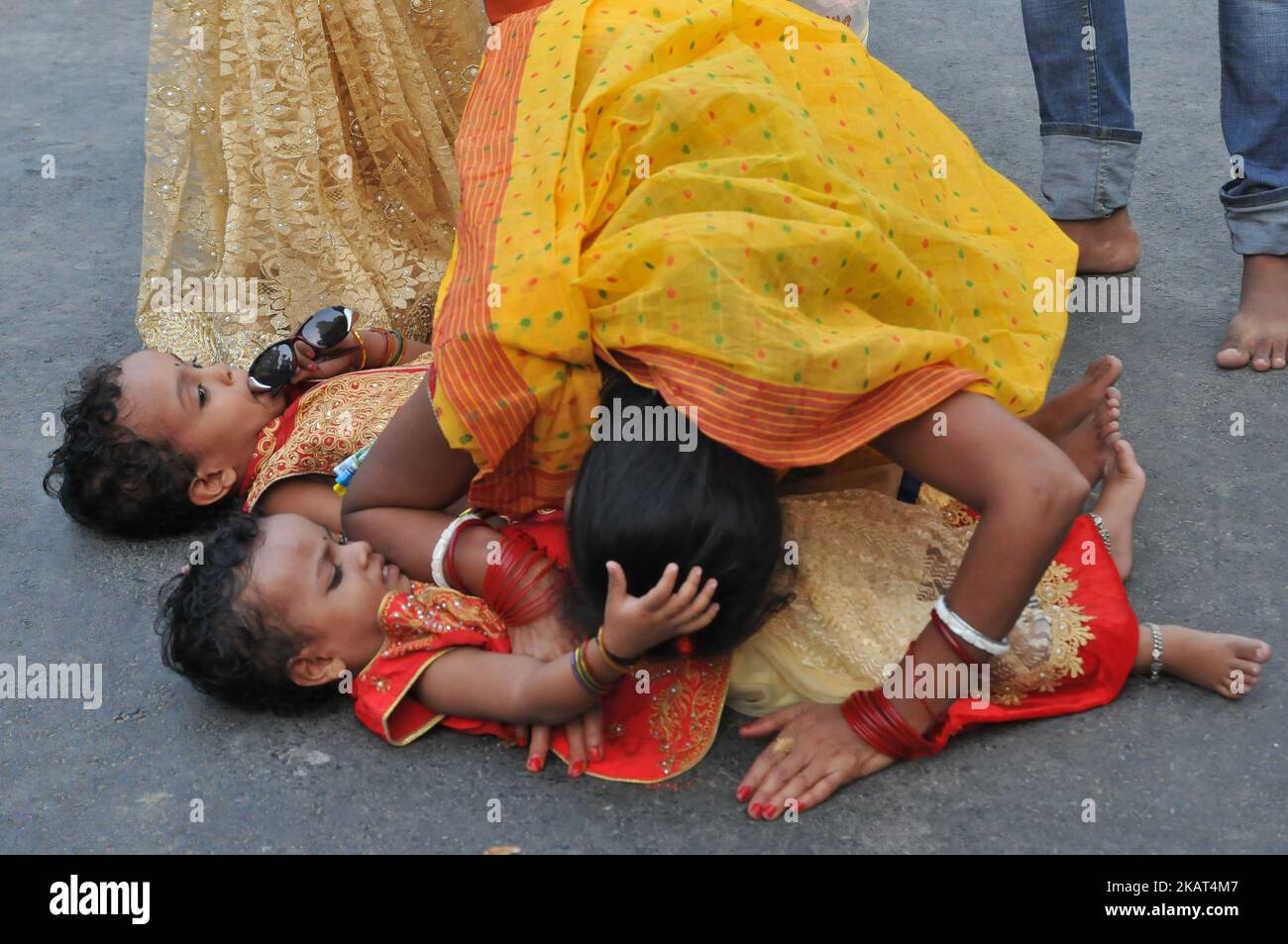 Devotees cross over children lying on the road during Chhata Puja ...