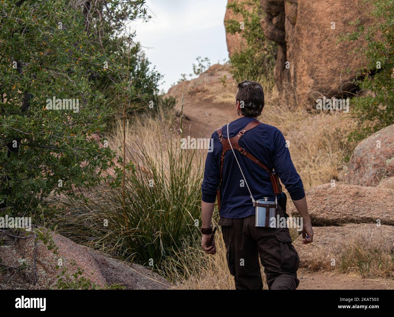 A back view of a caucasian man hiking on a trail at Lake Watson Stock ...