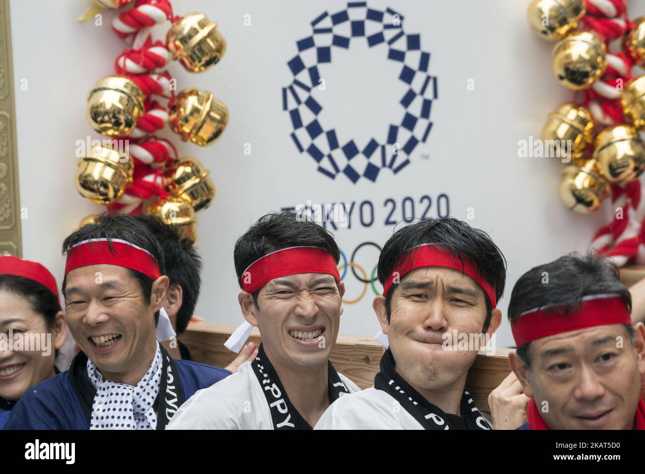 Participants carry portable floats featuring number of 1,000 as they ...