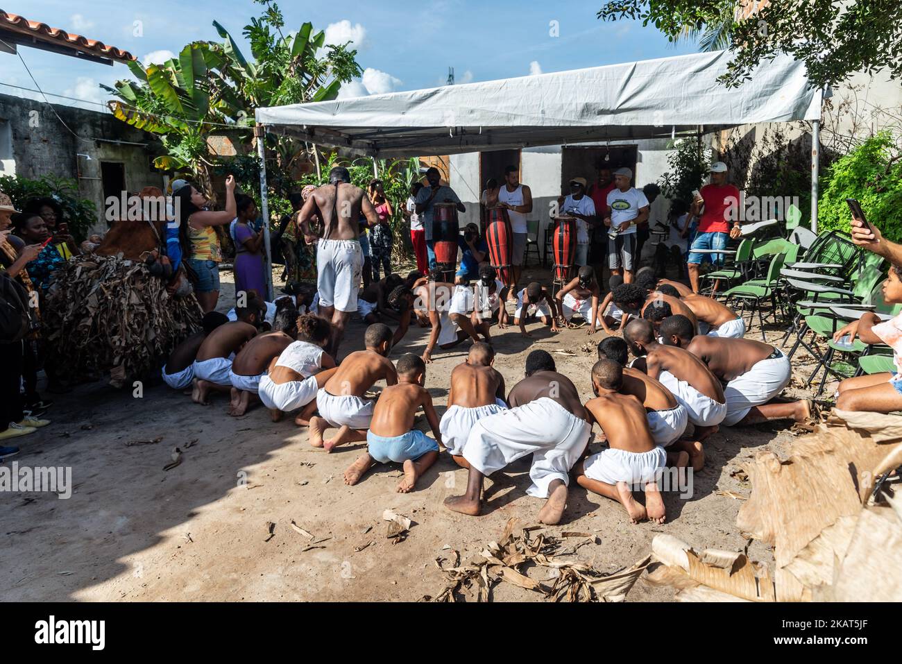 Members of the cultural event Nego Fugido sing and sit on the ground ...