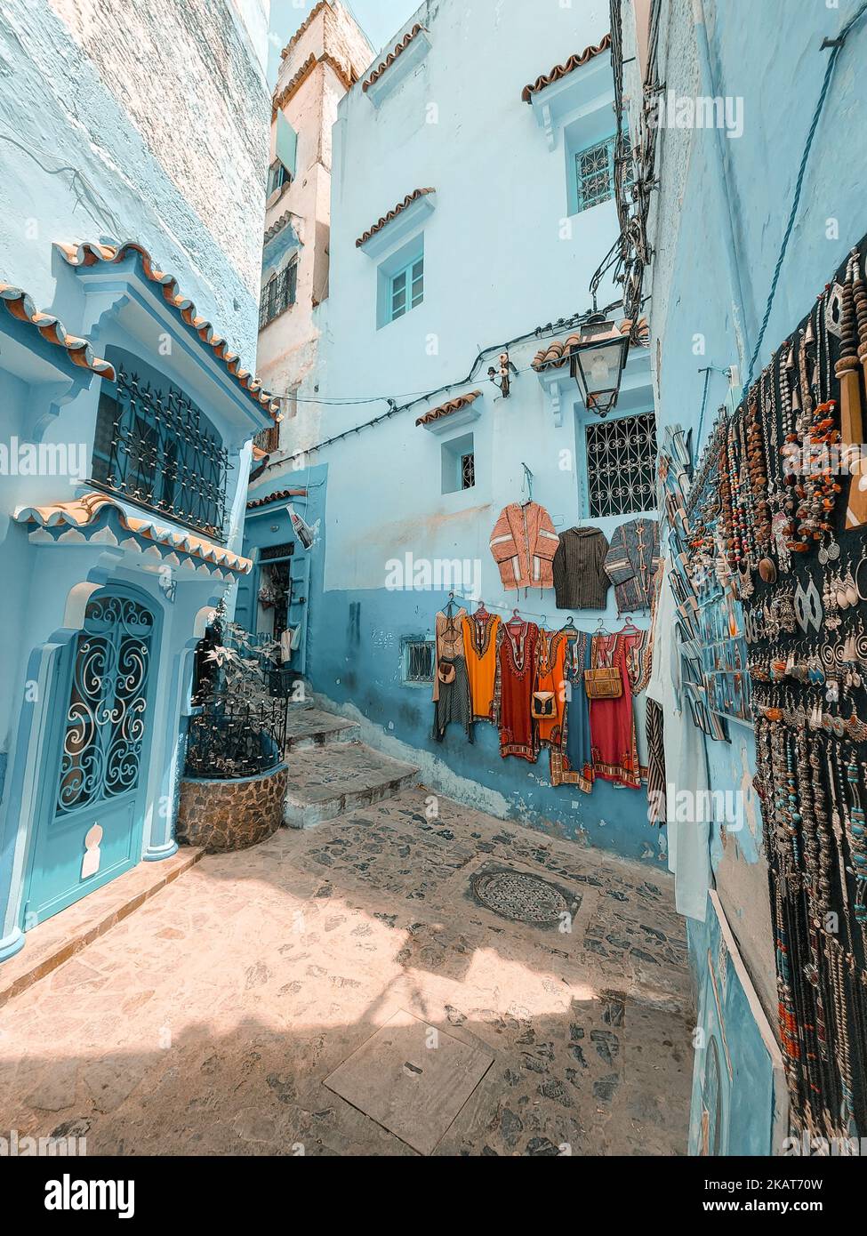 A narrow alley between beautiful blue-washed buildings in Chefchaouen ...