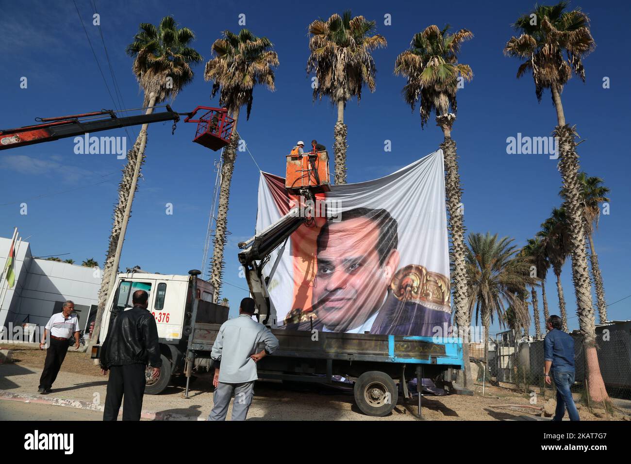 Palestinians hang a poster depicting Egypt's President Abdel Fattah al ...