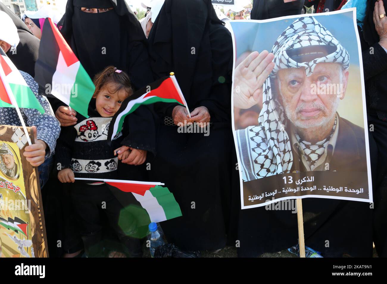 PalestinianS hold pictures of late leader Yasser Arafat in Gaza City on ...
