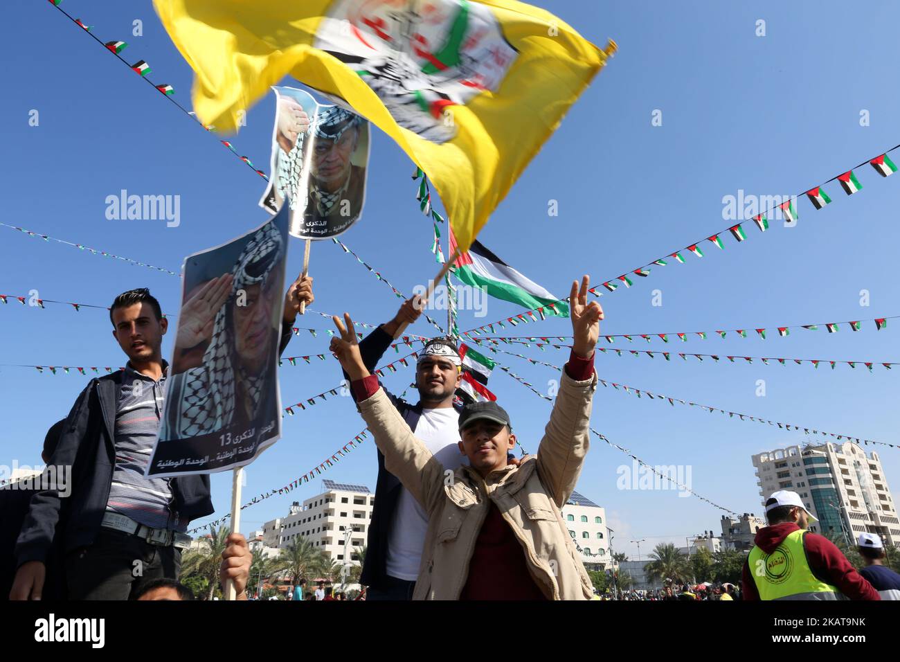 PalestinianS hold pictures of late leader Yasser Arafat in Gaza City on ...