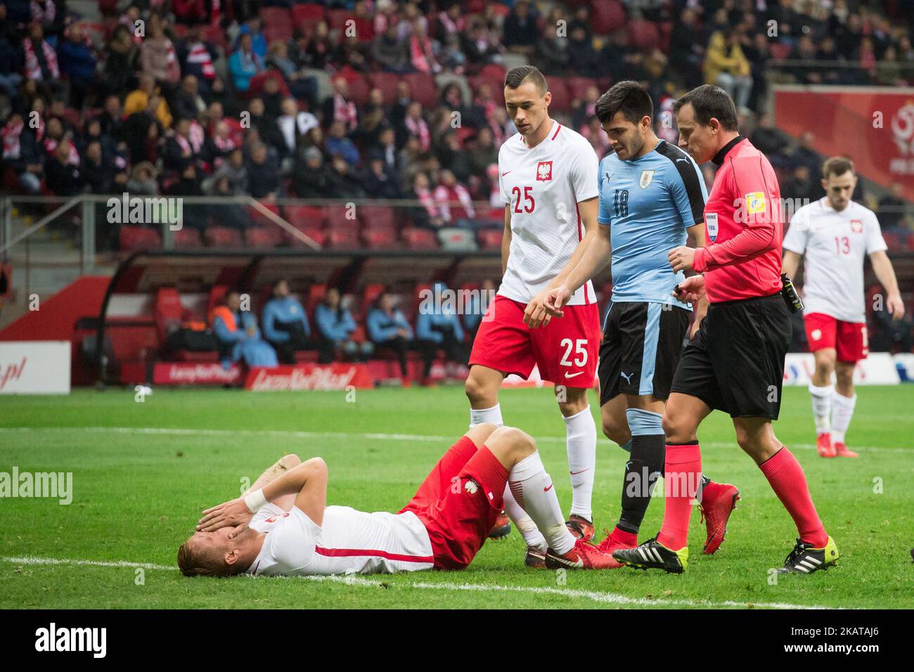 Kamil Glik (lying), Jaroslaw Jach, Maximiliano Gomez and referee Istvan ...