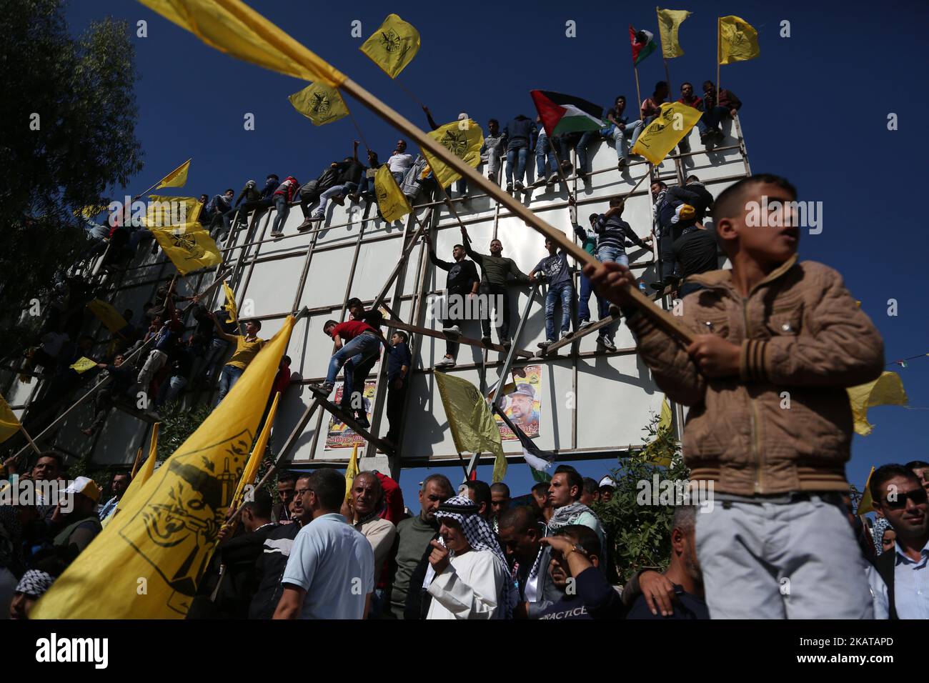 Fatah supporters wave the party flag as they take part in a rally in ...