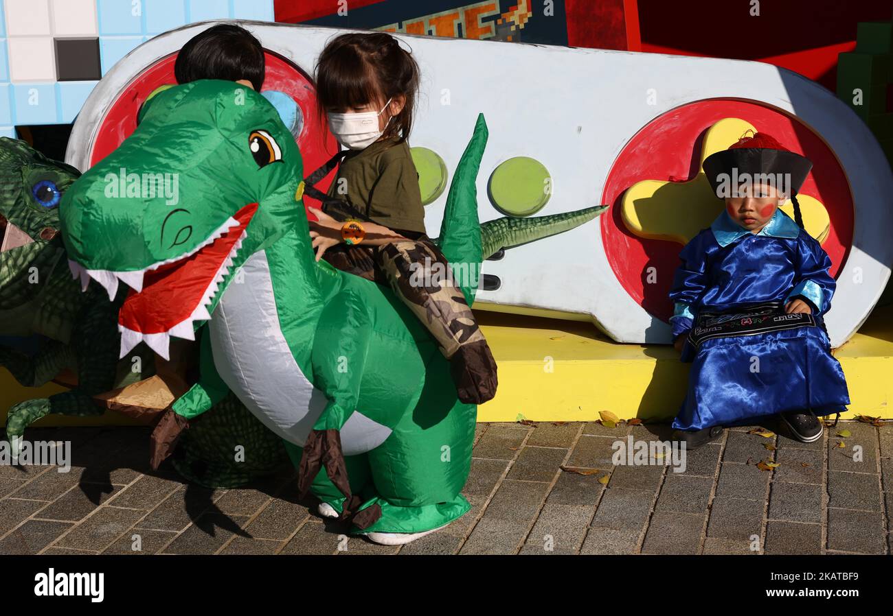Edward Tang Cheuk-Kiu (right), 2 yrs-old, is seen here dressing in a ...