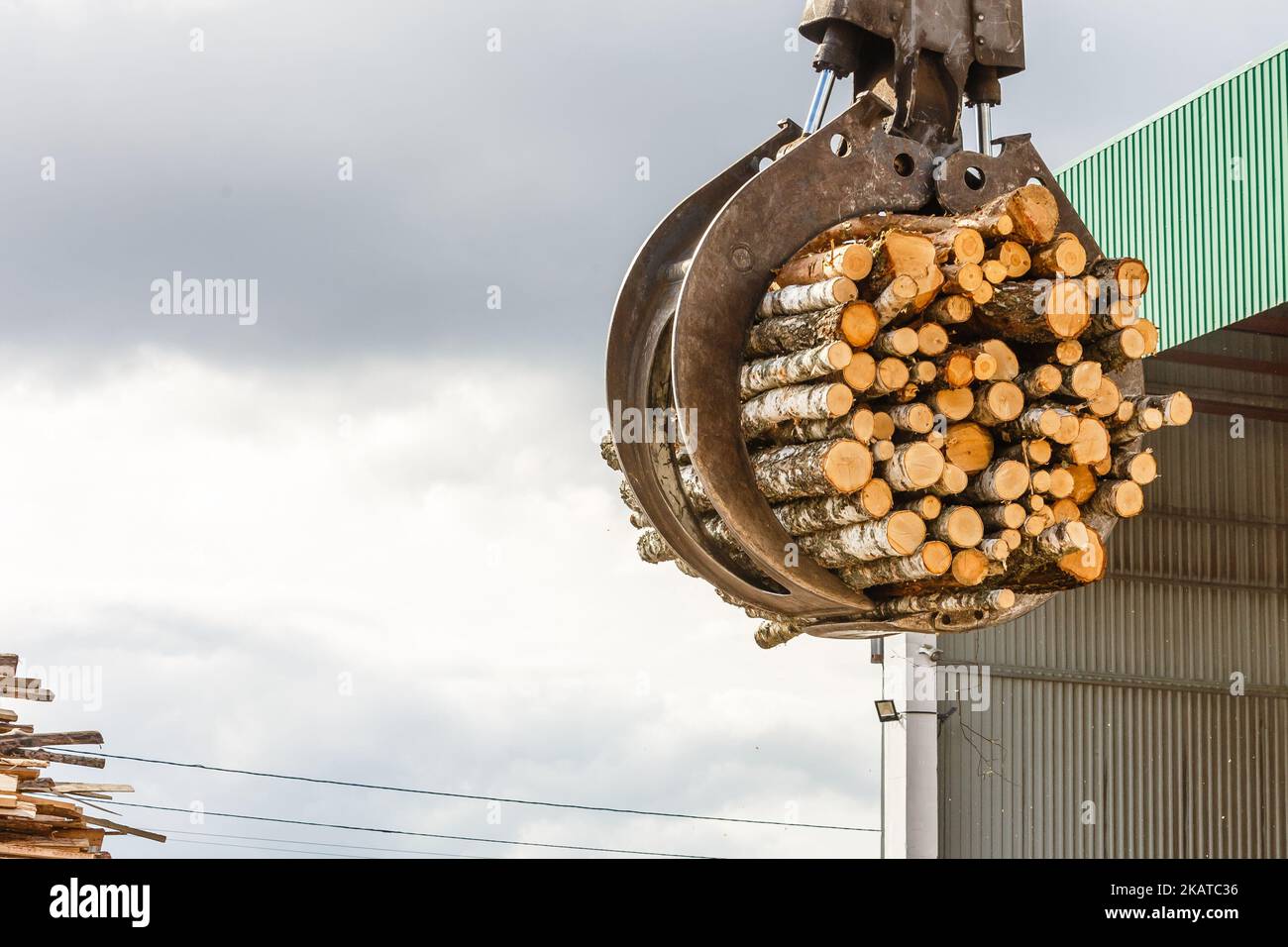 Log loader or forestry machine loads a log truck Stock Photo - Alamy